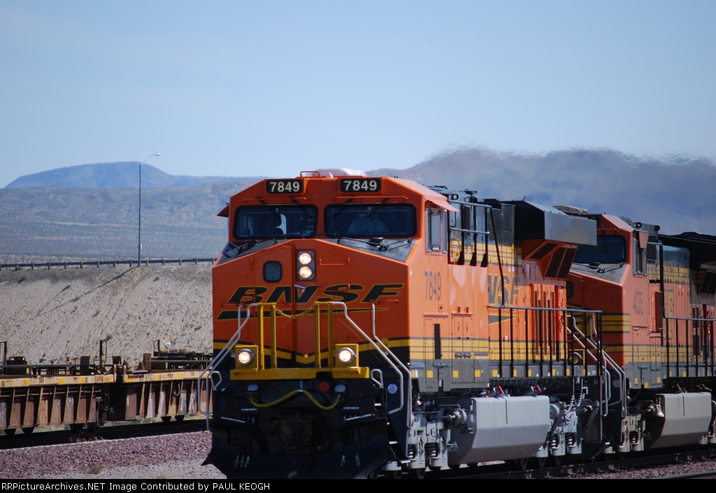 Close up shot of a Brapd new ES44DC BNSF 7849 (You can clearlly see the engineer and conductor ...